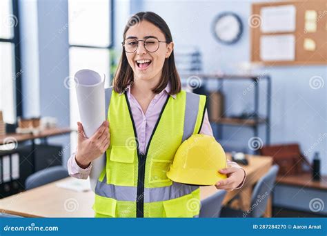 Hispanic Girl Architect Holding Build Project Blueprints Winking