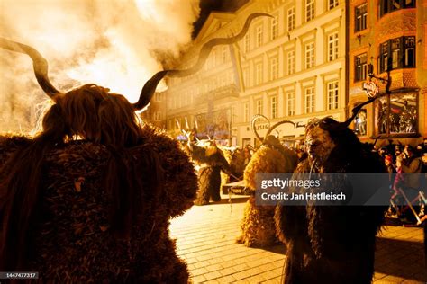 Men Wearing Horned Wooden Masks And Dressed As The Krampus Creature