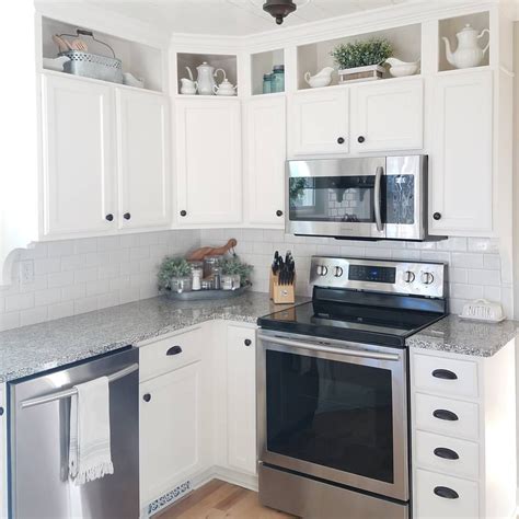 Farmhouse Kitchen With Shelves Cubbies Above White Cabinets