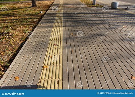 Yellow Tactile Tiles Are Installed On Outdoor Pedestrian Walkways To