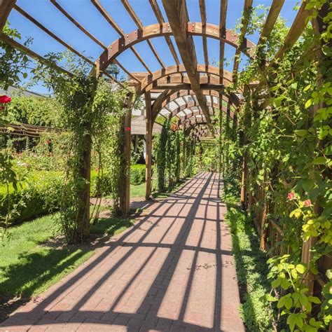 Square Stone Brick Passageway Benath An Arbor At A Sunny Garden Wedding