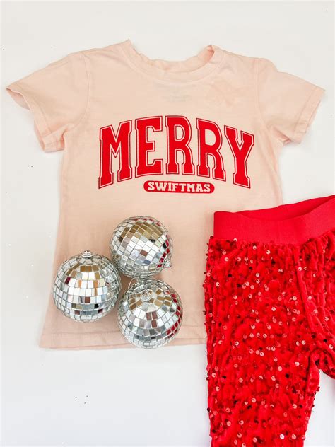 Merry Swiftmas Tee In Seashell Brokedown Clothing