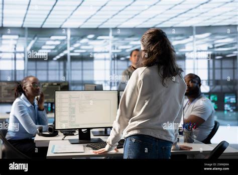Manager Supervising Multiethnic Team Working In Data Center Raising