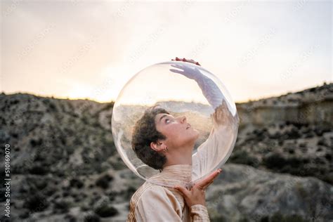Art Portrait Of A Girl With Dress And Bubble Helmet In The Desert