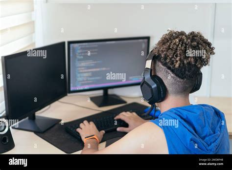 Software Engineer Sitting At Desk And Typing On Computer Keyboard While Creating Code While