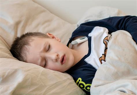 Premium Photo Cute Boy Sleeping On Bed