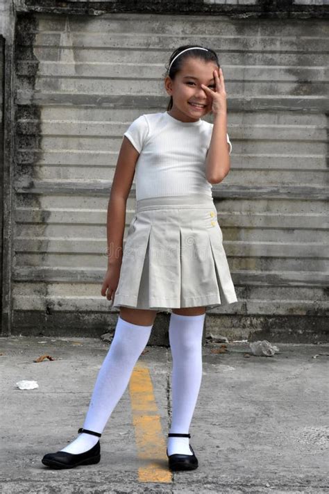 Shy Young Philippina Person Wearing Skirt In Parking Lot Stock Image