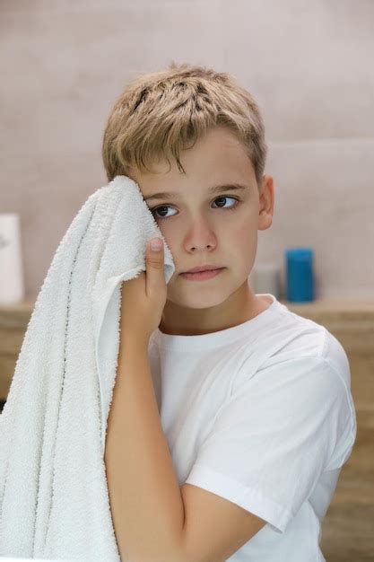 Premium Photo Reflection Of Schoolboy Wiping His Face With A Towel