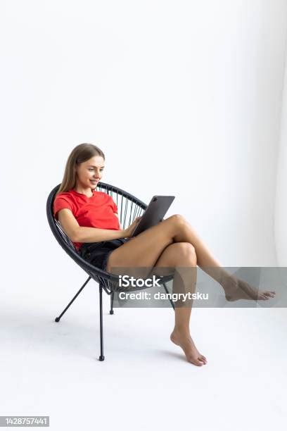 의자에 앉아 흰색 스튜디오 벽 여유 공간에 대해 온라인으로 작업하는 디지털 태블릿을 가진 쾌활한 젊은 여성의 초상화 현대 기술 및 통신 개념 공부에 대한 스톡 사진 및 기타