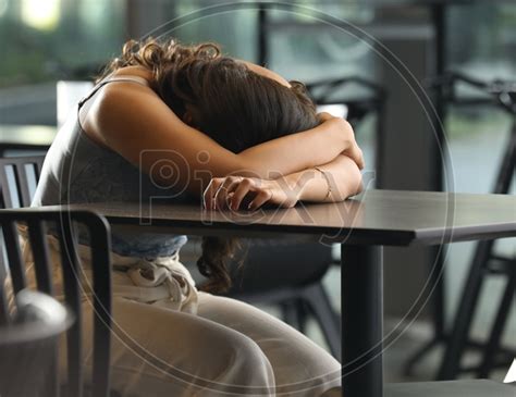 Image Of Young Girl Lying Head On Table Or Unhappy Or Uneasy Girl