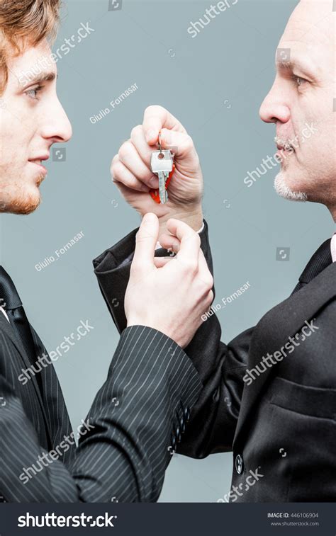 An Older Man Giving Keys To A Babeer Man Over 1 Royalty Free Licensable Stock Photos