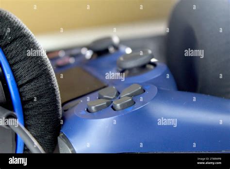 A Photo Of A Dark Blue Playstation Gaming Console Controller And A Pair
