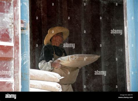 Woman Unloading A Container At The Riverside Docks Yangshuo Southwest China Stock Photo Alamy