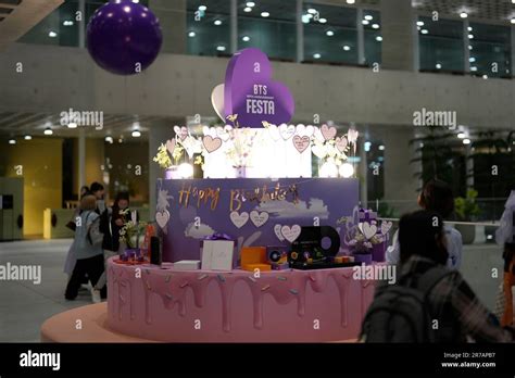 Fans Of Bts Walk Around A Giant Cake Shaped Installation During An