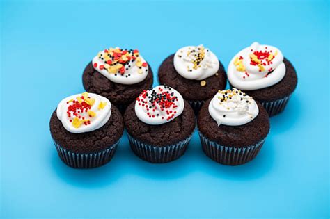 흰색 아이싱과 다채로운 설탕이 있는 홈메이드 컵케이크가 파란색 배경에 뿌려져 있습니다 생일 발렌타인 데이 어린이 휴가 부활절과 함께 0명에 대한 스톡 사진 및 기타 이미지