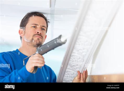 Man Is Installing The Baseboard Repair Works Indoor Stock Photo Alamy