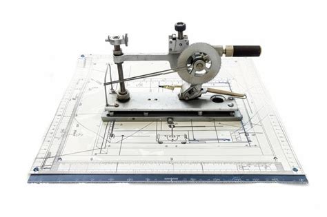 An Intricate Drafting Tool Rests On Technical Blueprints Showcasing