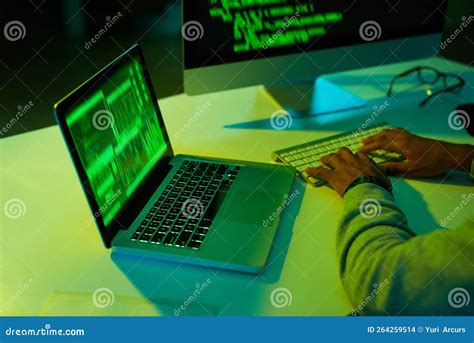 Getting Up To No Good In The Dark An Unrecognizable Hacker Cracking A Computer Code In The Dark