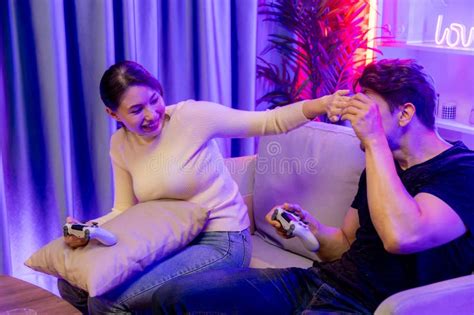 Couple Joyful Funny Playing Game Using Joysticks Trying To Disturb