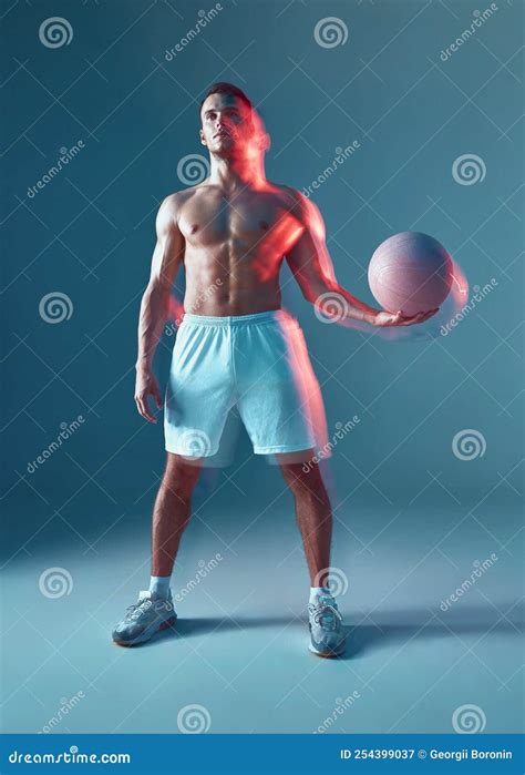 Male Basketball Player With Ball And Muscular Naked Torso Standing In