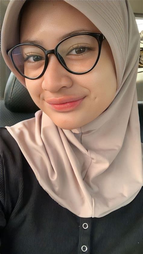 A Woman Wearing Glasses And A Hijab
