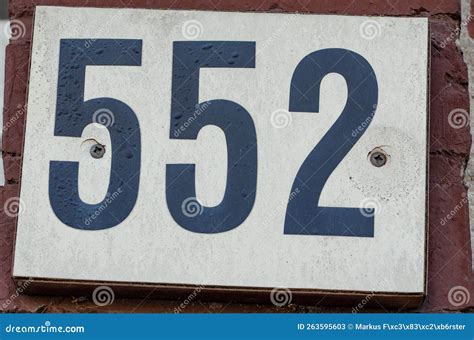 A Sign On A Wall With The Number Five Hundred Fifty Two Stock Image Image Of Decoration Door