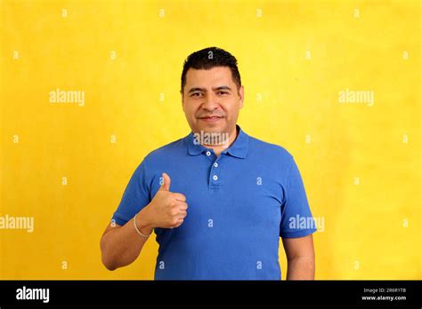 Dark Haired 40 Year Old Latino Man Shows Mexican Sign Language Used To Communicate Between The