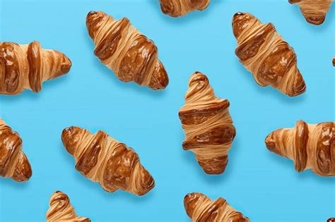 premium photo tasty croissant pattern on a blue background with strong lighting designed
