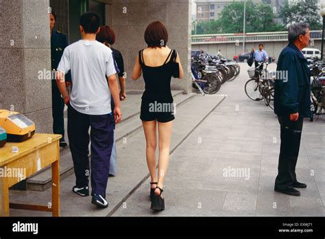 A Chinese Girl Walking On Road In High Heels And Short Dress China