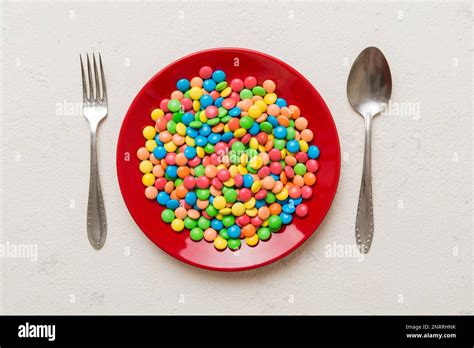 Cutlery On Table And Sweet Plate Of Candy Health And Obesity Concept
