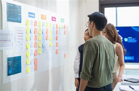 Brainstorming Session Using Sticky Notes On A Task Board Kanban To
