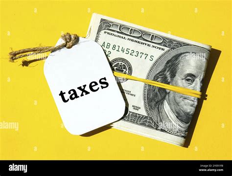 Paper Note Written Word Taxes In Black Letters Around Us Dollars