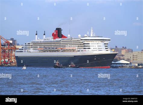 Queen Mary 2 Luxury Cruise Ship Docked At A Port Surrounded By