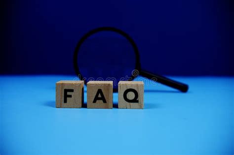 Faq With Wooden Blocks Alphabet Letters And Magnifying Glass On Blue Background Stock Image