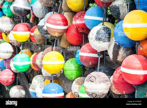 Colorful Styrofoam Fishing Net And Crab Lobster Trap Floats Hanging On A Roadside Stand In The
