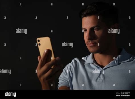 Man Unlocking Smartphone With Facial Scanner On Black Background Biometric Verification Stock