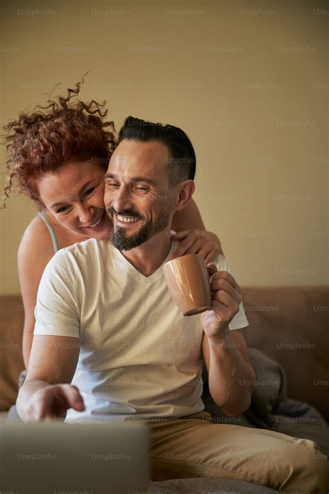 Lovely Mature Couple Embracing And Enjoying Themselves On Their Bed At