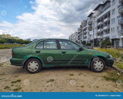 Old Rusty Dented Scrap Green Car Nissan Almera Four Doors Sedan