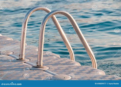 Boarding Ladder For Swimmers Mounted On A Plastic Floating Dock Stock Image