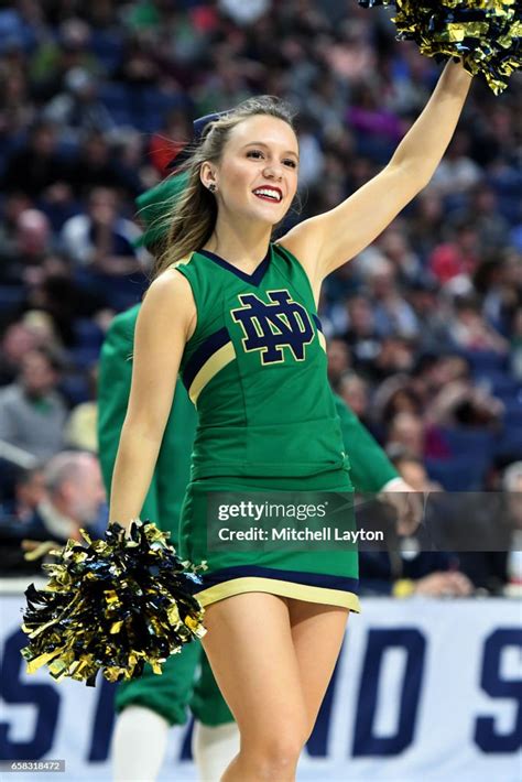 A Notre Dame Fighting Irish Cheerleader Performs On The Floor During