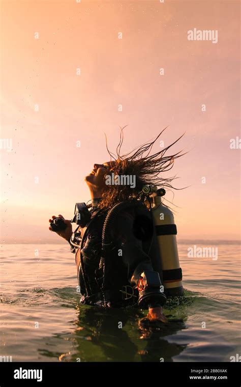 Female Scuba Dive Instructor Wearing A Dry Suit A Twin Tank And