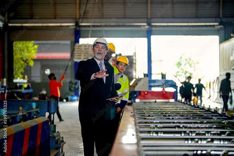 Senior Boss Manager Inspecting With Staff Engineers Woman And African