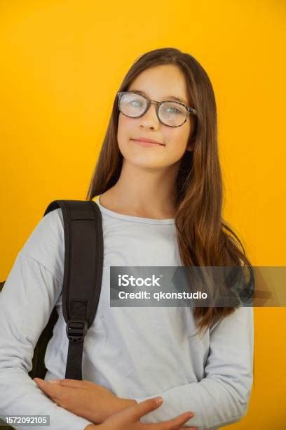 Little Beautiful Smart Girl Schoolgirl In Glasses With Backpack Looks