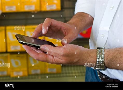 Man Using PDA Personal Digital Assistant In Computer Store Stock Photo Alamy