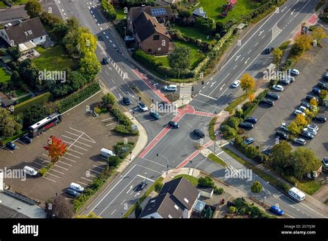 Aerial View Road Traffic And Red Bicycle Lane Markings Intersection