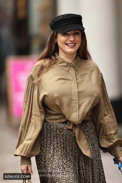 Kelly Brook Arrives At Heart Radio In A Satin Blouse And Pleated Skirt
