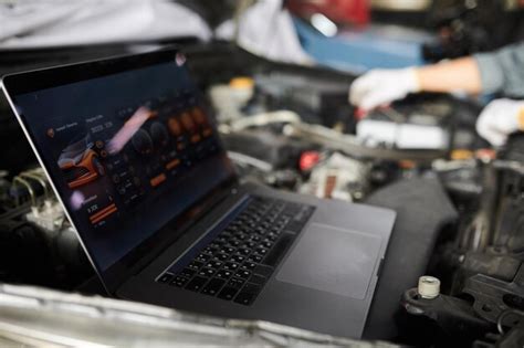 Premium Photo Mechanics Using Program On Laptop When Analyzing Car Computer Systems And Components