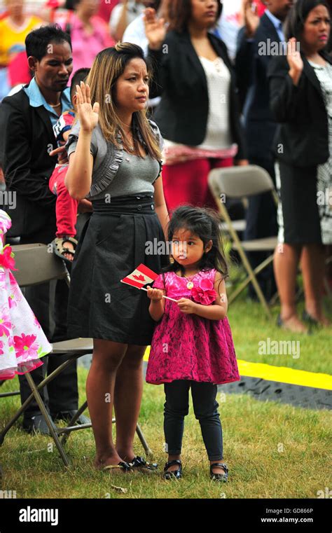 New Canadian Citizens Take Part In A Citizenship Ceremony At A Canada