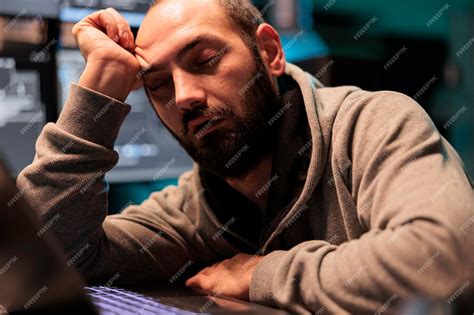 Premium Photo Tired Male Programmer Falling Asleep At Office Desk Working On Interface