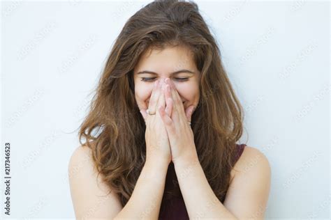 Zdjęcie Stock Embarrassed Girl Laughing And Covering Mouth With Hands